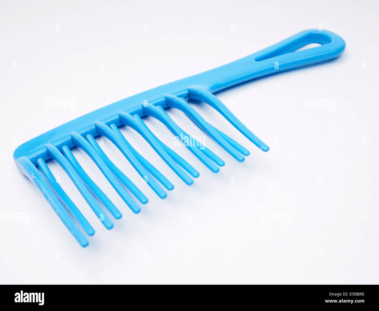 Blue plastic comb cut out isolated on white background Stock Photo - Alamy