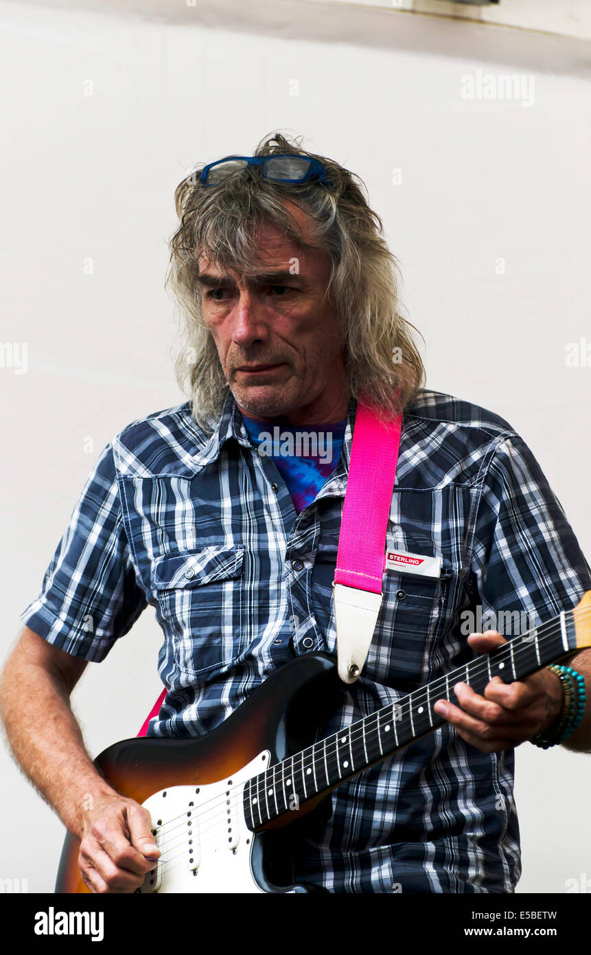 Guitarist performing with the Jensen Interceptors at the Mardi Gras ...
