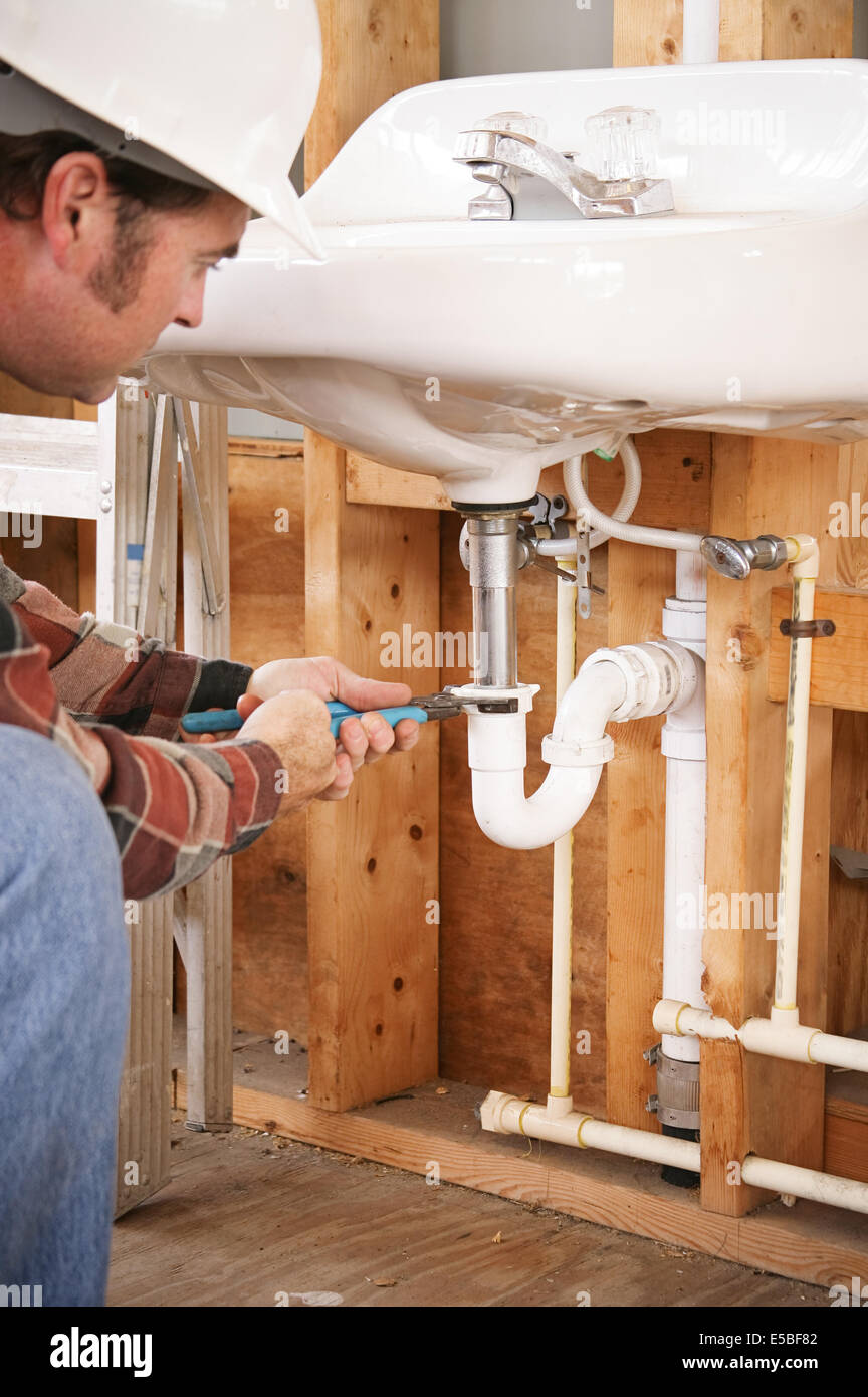 Construction plumber instaling a sink in a new building or renovation ...