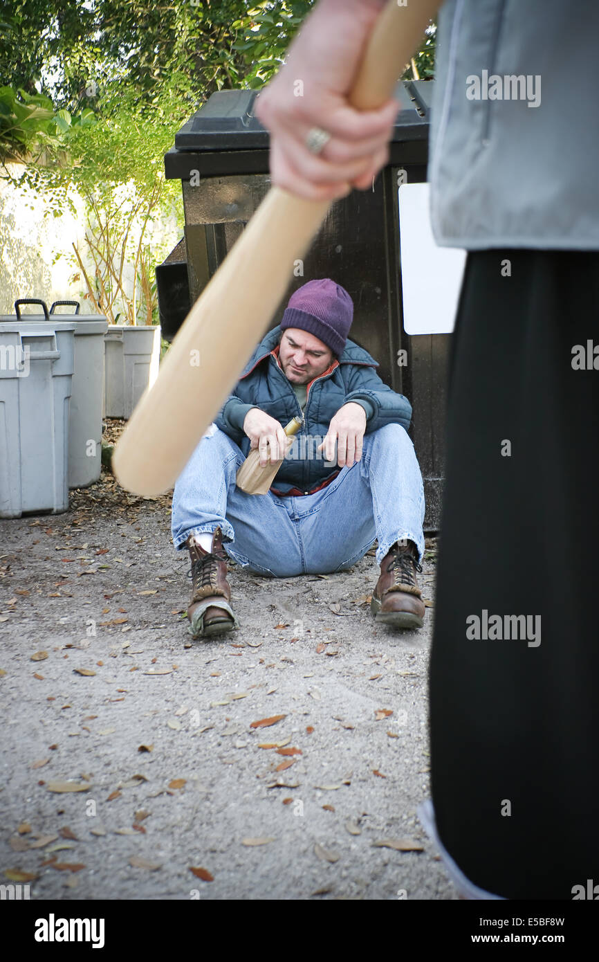 Young thug with baseball bat about to attack a homeless man Stock Photo ...