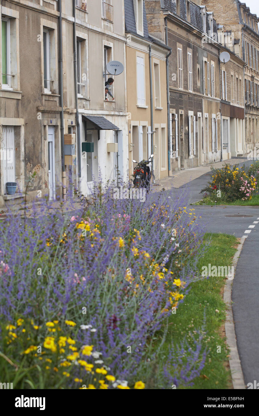 Two boys looking out window in street at Falaise, Calvados, Normandy in ...