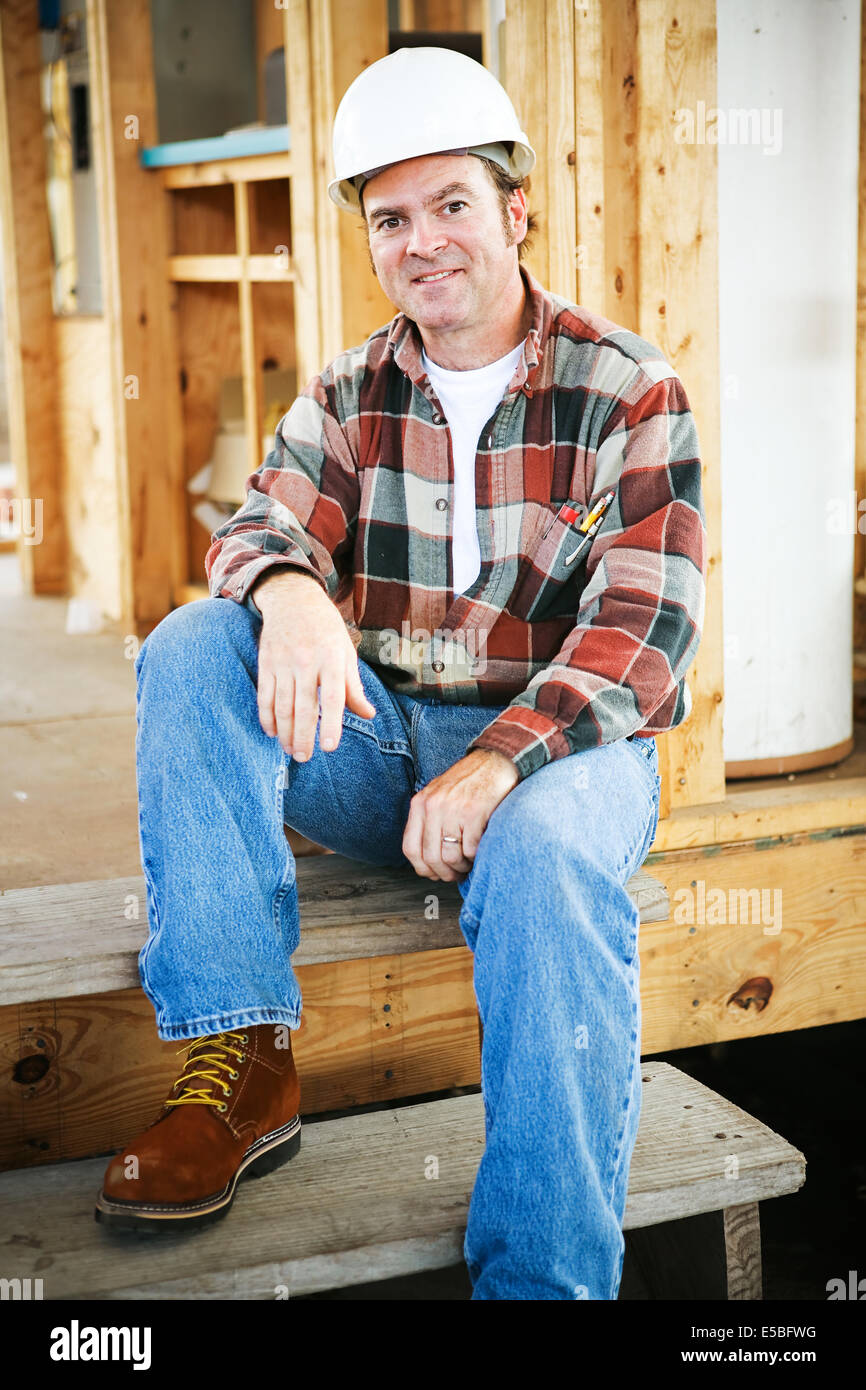 Handsome construction worker taking a break on the job site Stock Photo ...