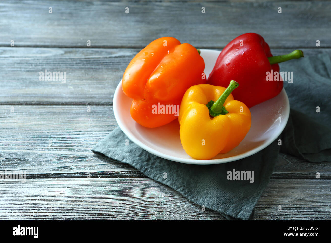 ripe peppers on a white plate, food closeup Stock Photo - Alamy