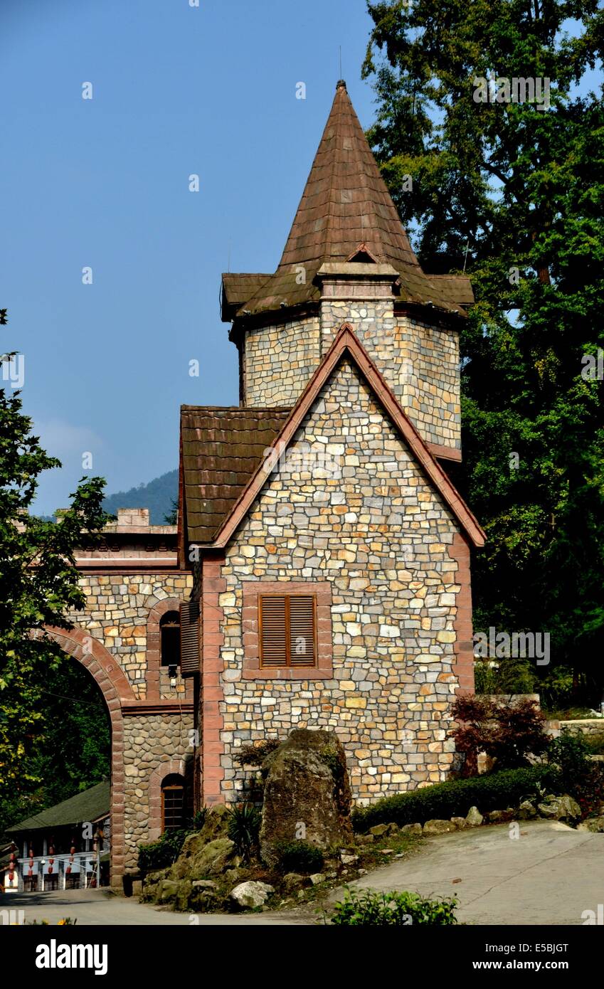 BAI LU TOWN, CHINA: A French-Swiss style stone gatehouse with turret ...