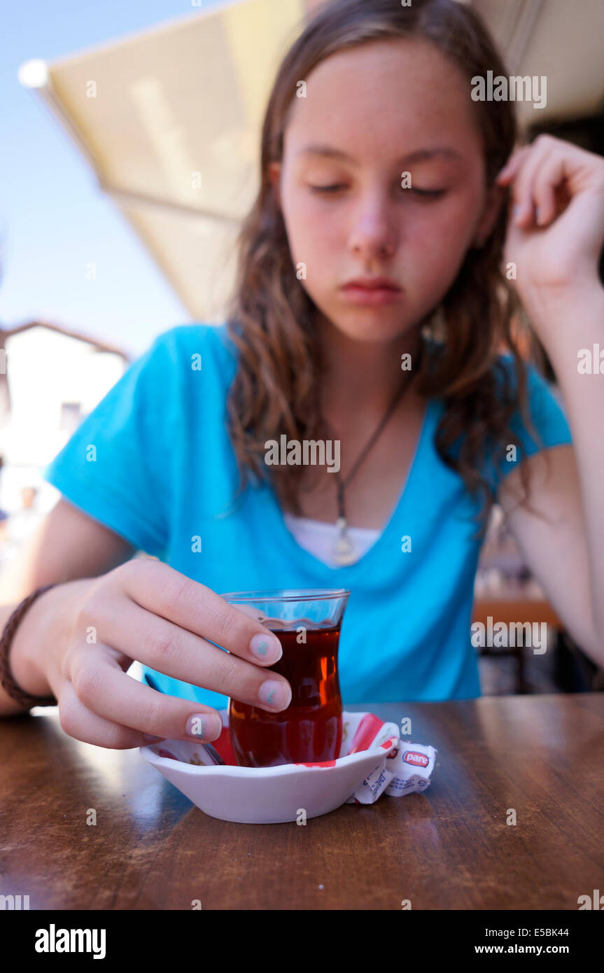 Young woman drinking Turkish Tea, Cesme, Turkey Stock Photo - Alamy