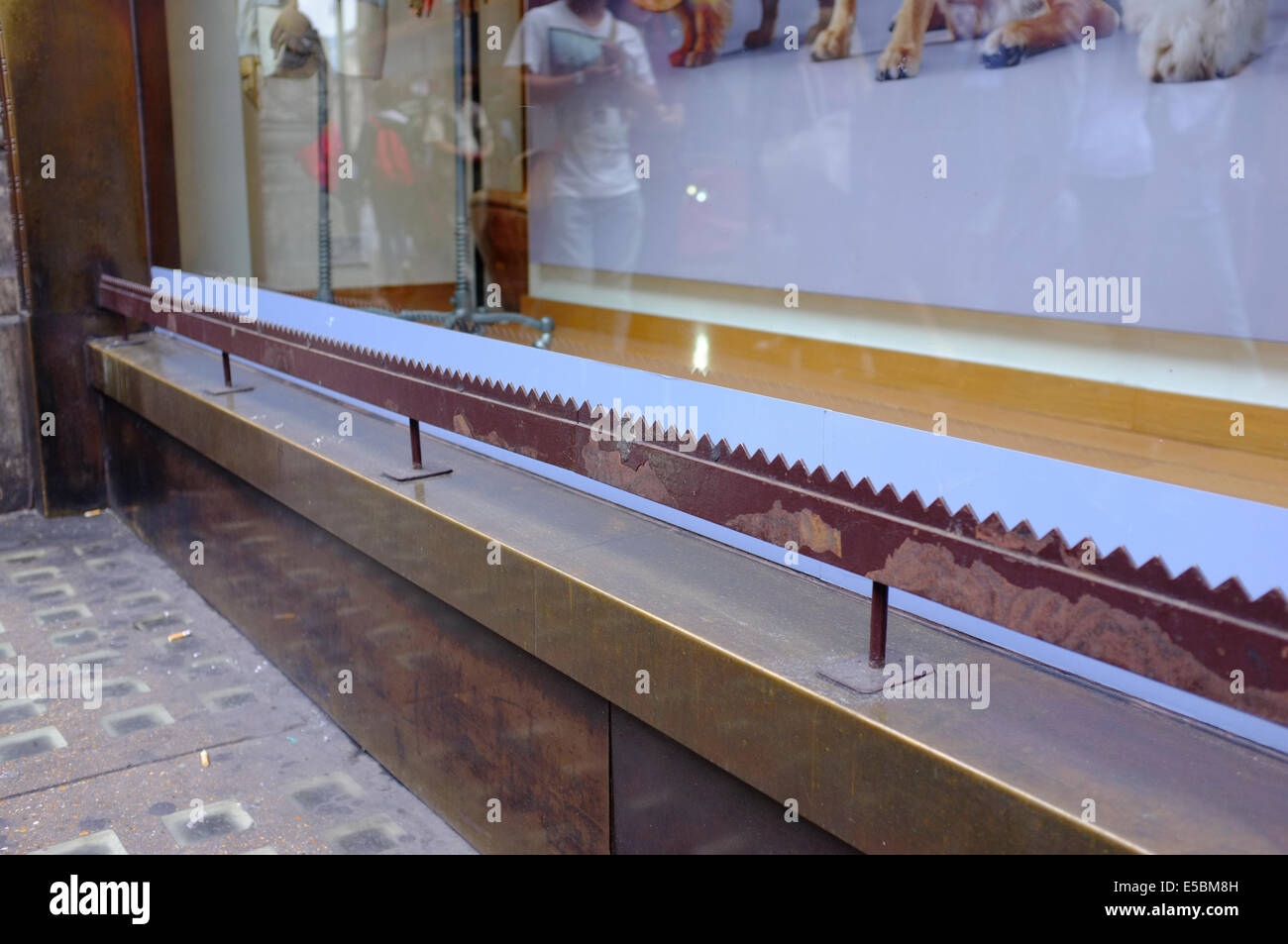 serrated metal bar to prevent people sitting or sleeping on shop window ...