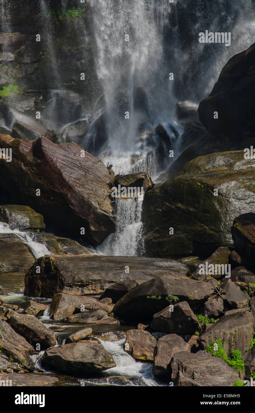 A close up view of water falling over large boulders Stock Photo - Alamy