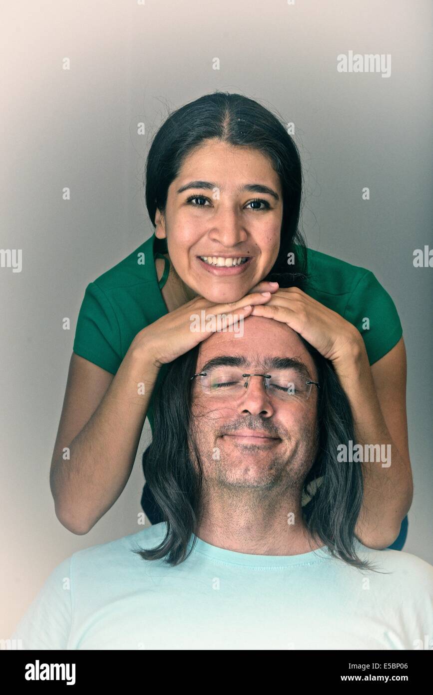 Couple having fun in a photo booth Stock Photo - Alamy
