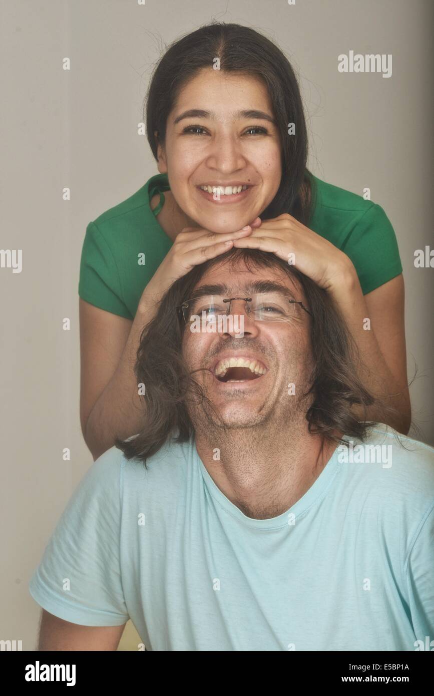 Couple having fun in a photo booth Stock Photo - Alamy