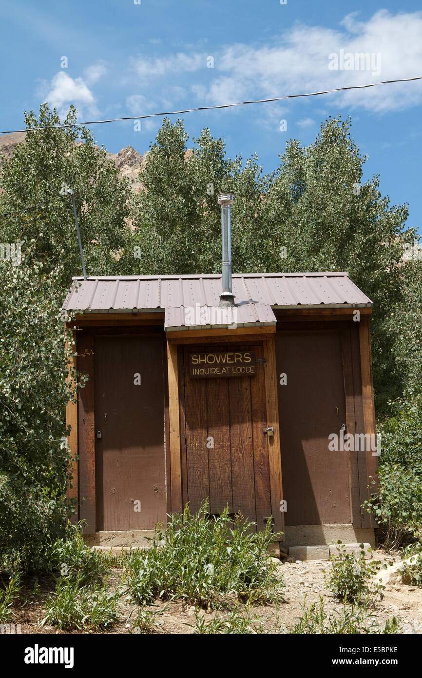 Wooden built outdoor pay showers with metal roof for visitors in the ...