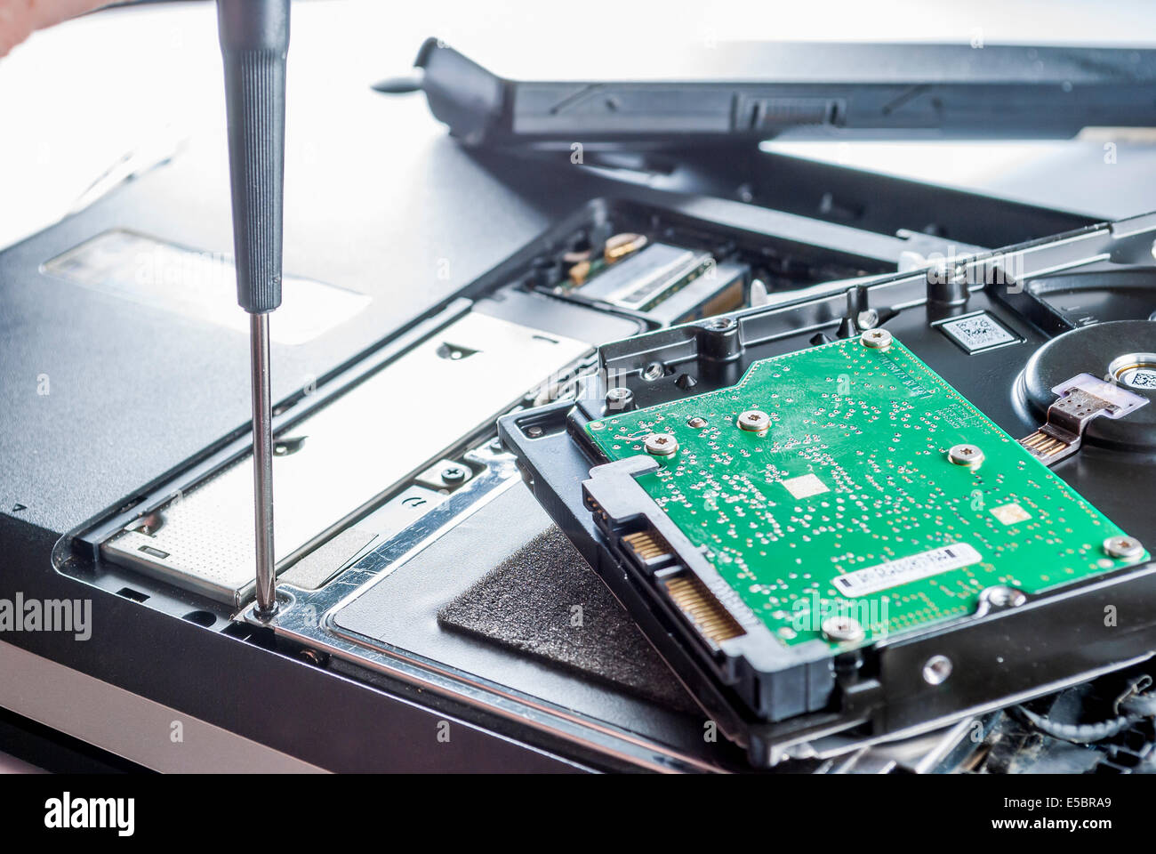 man fixing computer or laptop or notebook with crewdriver Stock Photo ...