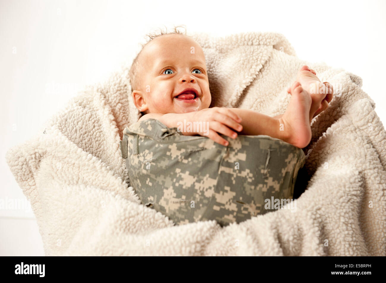 Cute baby sitting in an army helmet Stock Photo - Alamy
