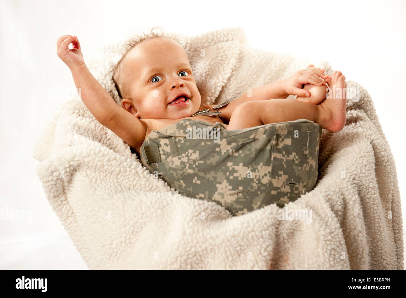 Cute baby sitting in an army helmet Stock Photo - Alamy