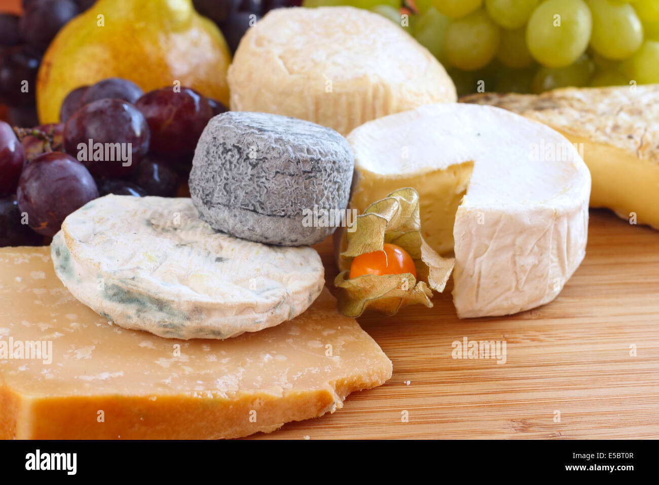 French cheese composition on wooden plank table Stock Photo - Alamy