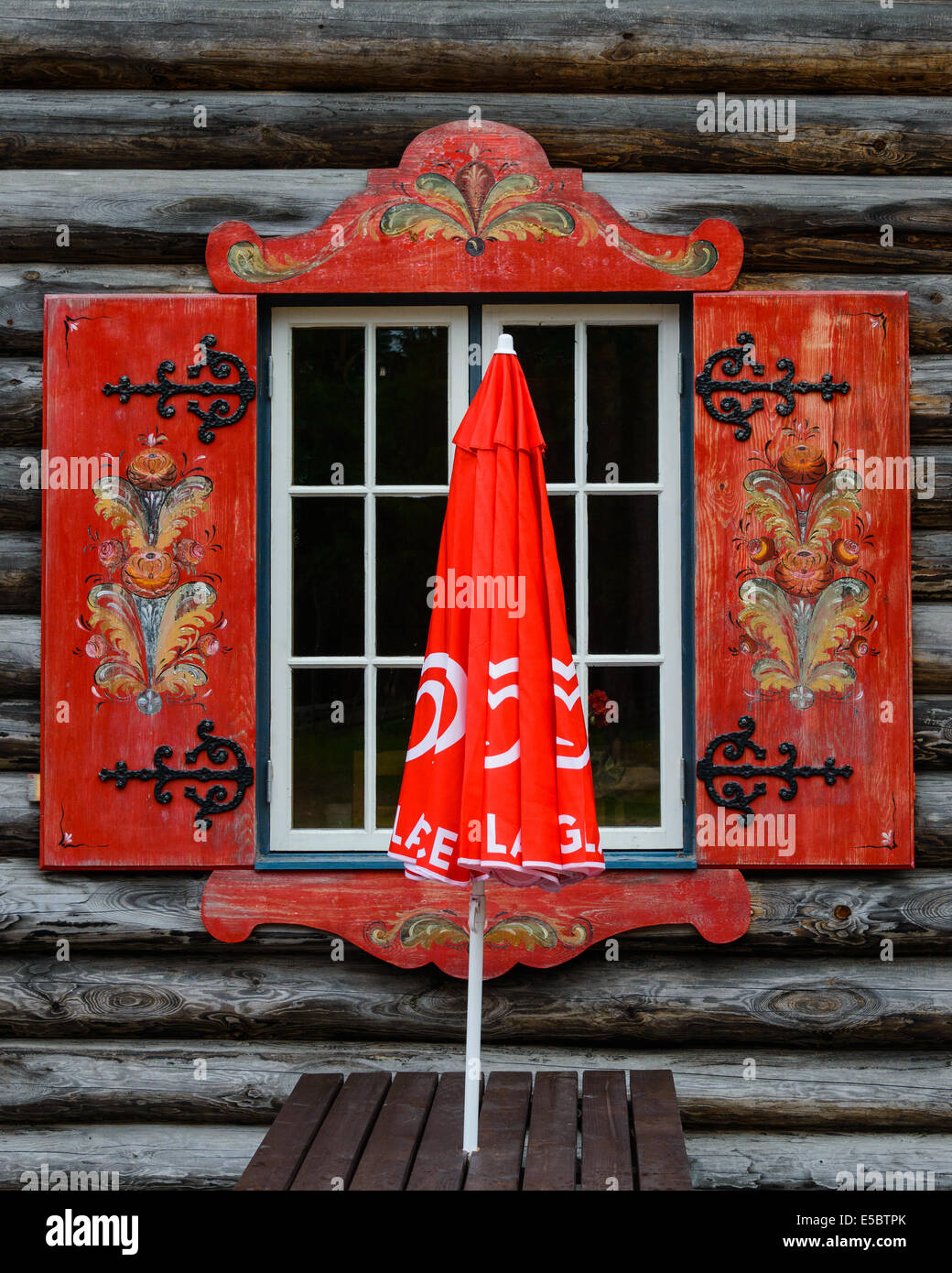 Closed parasol in front of old wooden window with red shutters Stock ...