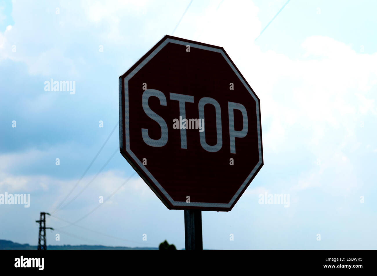 a poles of a power line and a stop sign. symbolic photo for phasing out ...