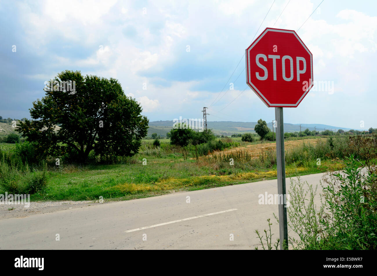 Stop sign in country road Stock Photo - Alamy