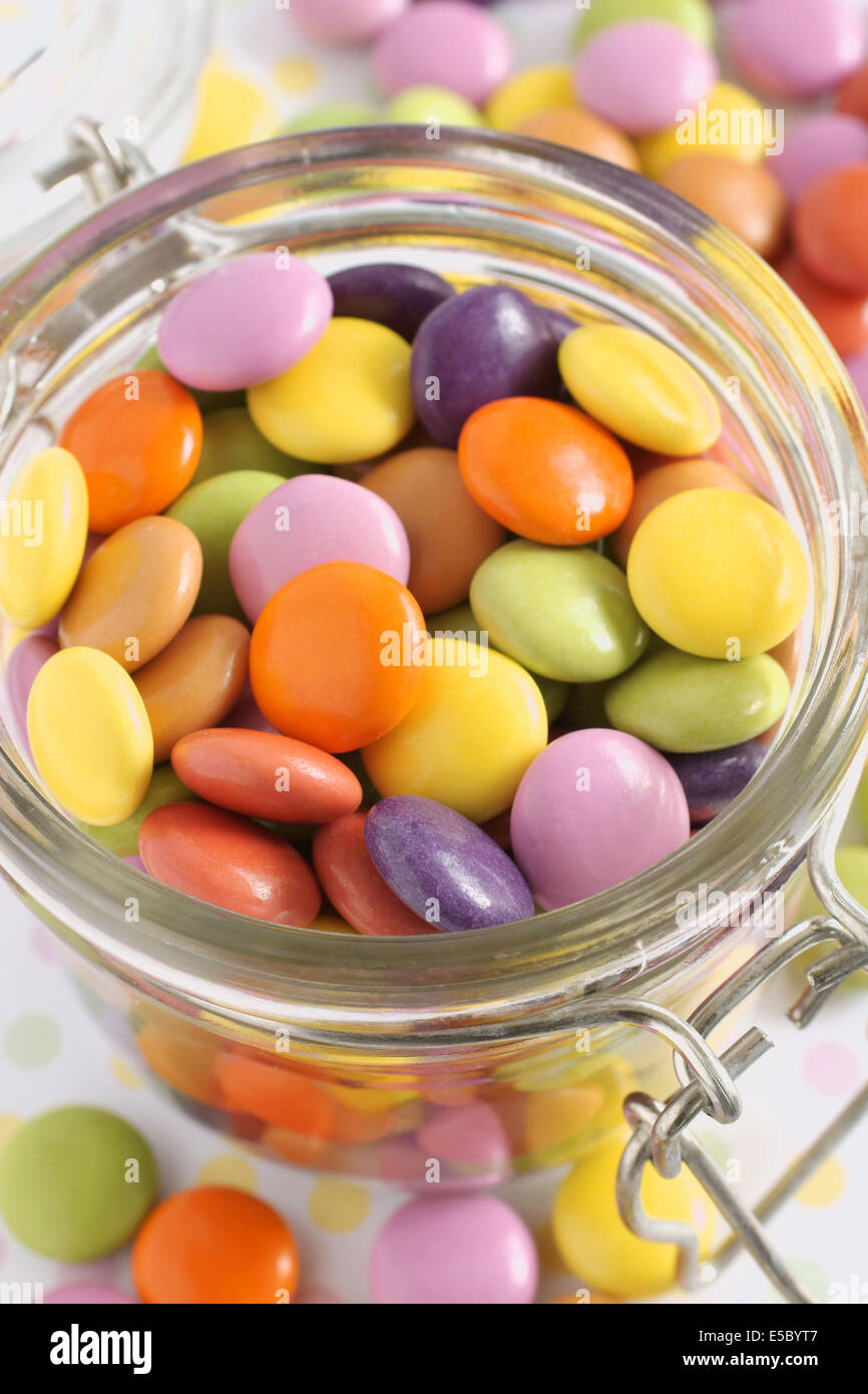 Crisp sugar shell coated chocolate beans or sweets in an old fashioned ...