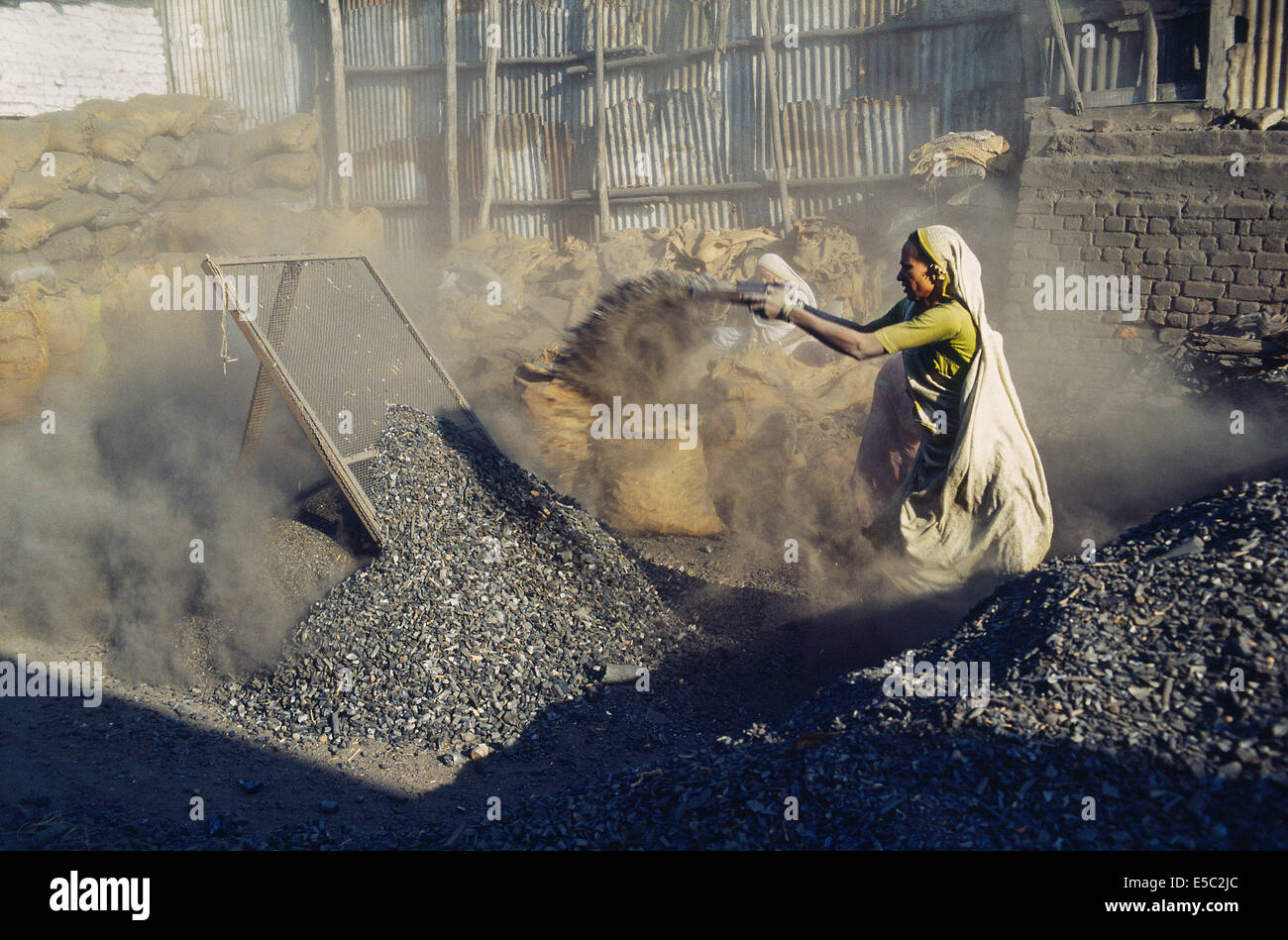 Woman sorting stones that are used for construction work ( India Stock ...