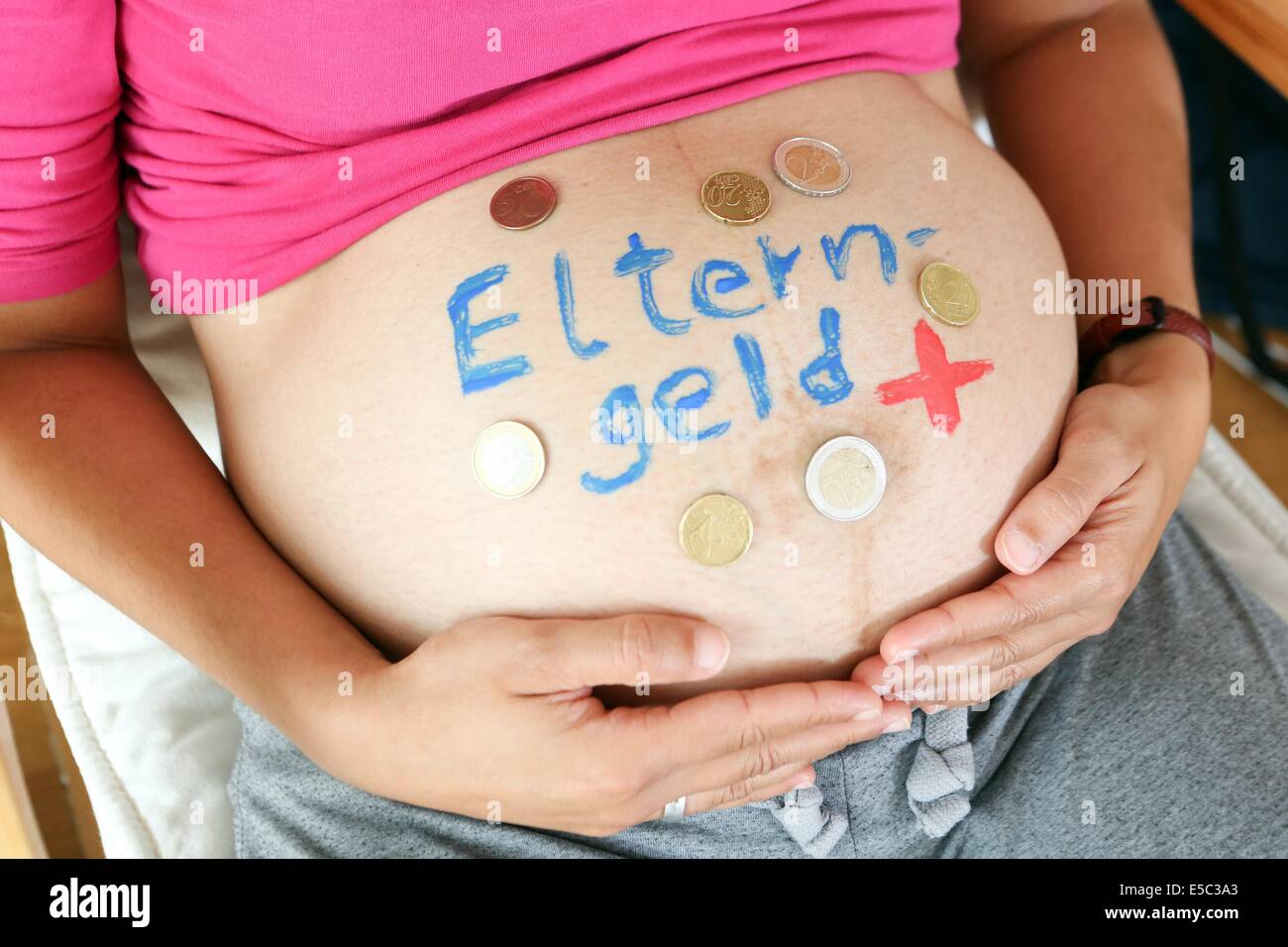 ILLUSTRATION - a nine months pregnant woman shows her belly which reads ...