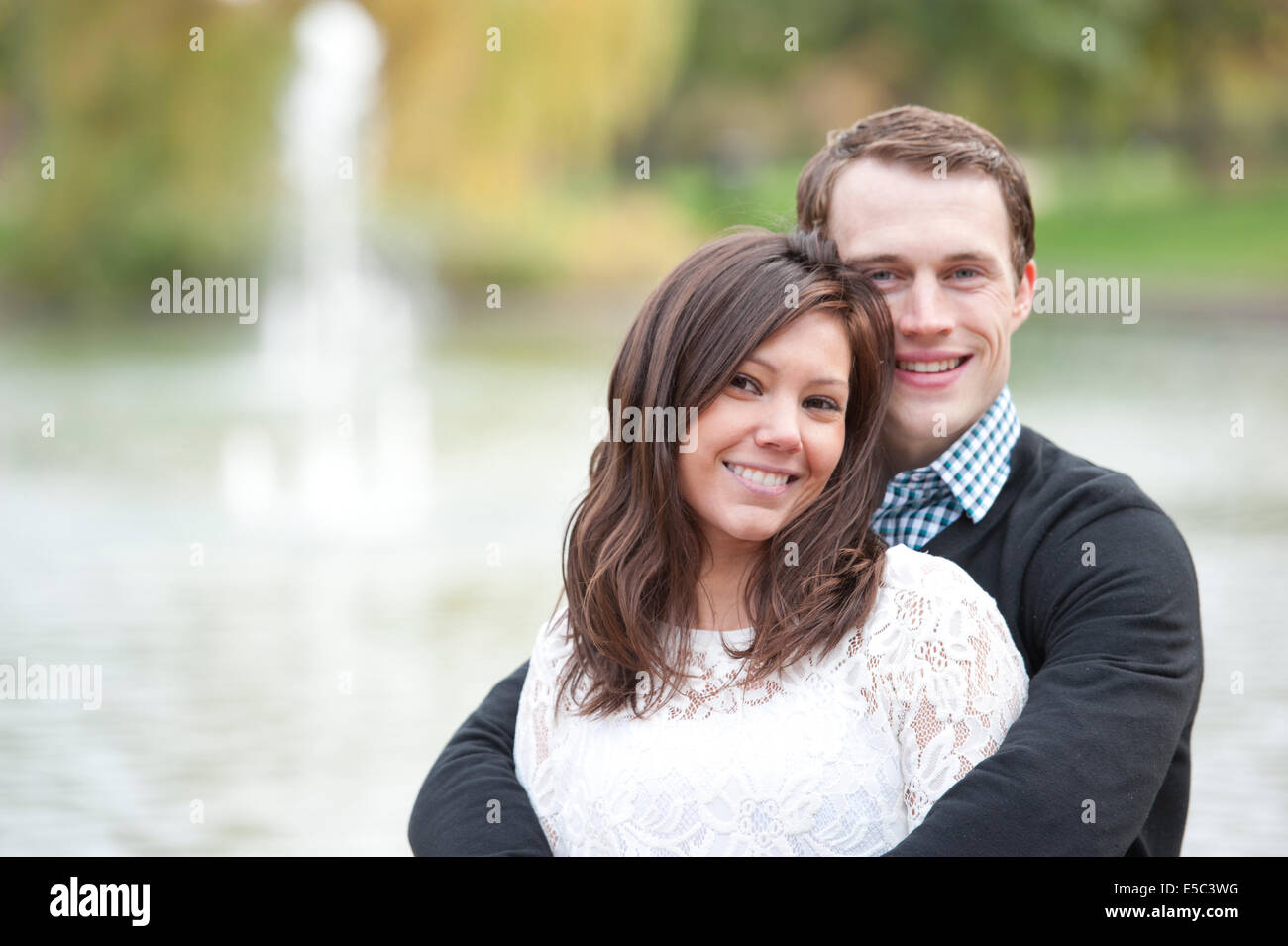 An attractive young couple posing by the pond on a sunny day Stock ...