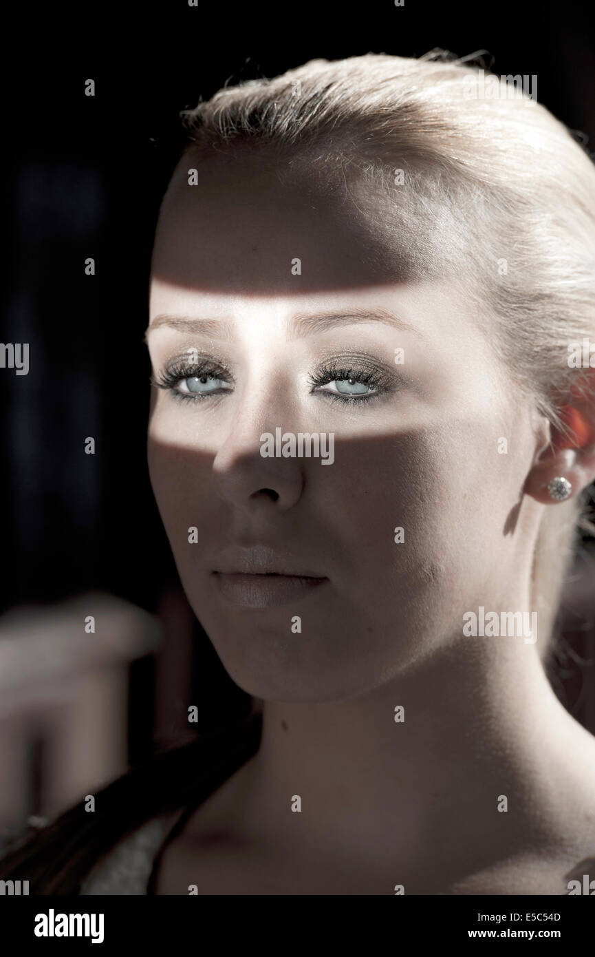 A gorgeous female blond model portrait lit with unique lighting for a ...