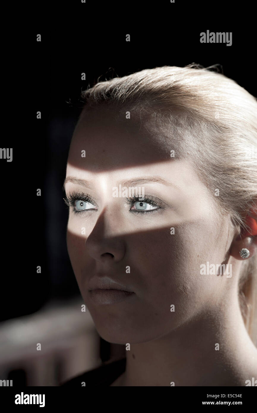A gorgeous female blond model portrait lit with unique lighting for a ...
