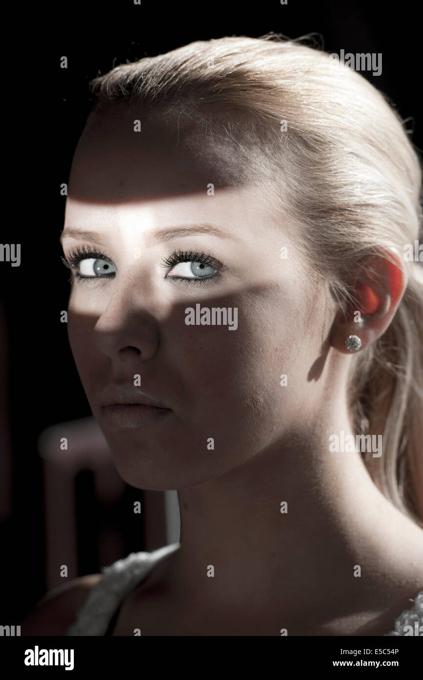 A gorgeous female blond model portrait lit with unique lighting for a ...