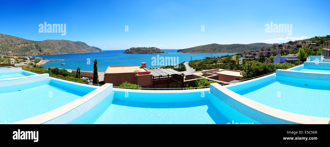 Panorama of swimming pools at luxury hotel with a view on Spinalonga ...