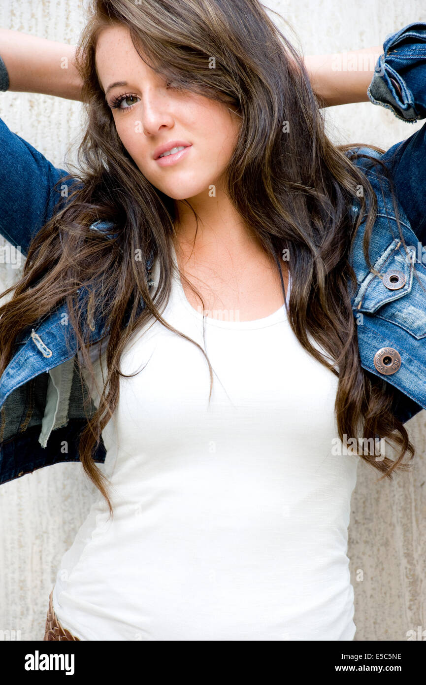 A gorgeous young model wearing a jean jacket on a sunny day Stock Photo ...