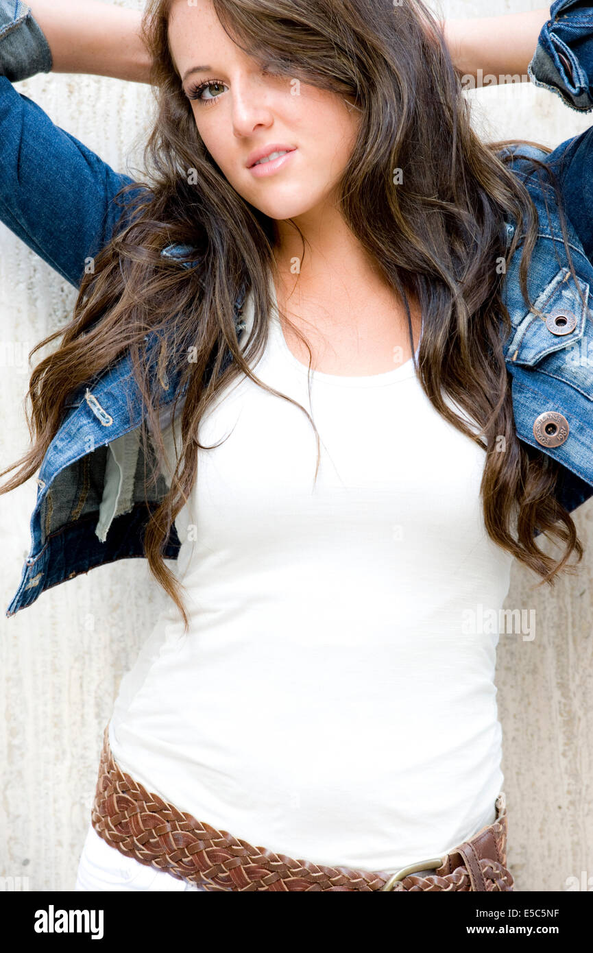 A gorgeous young model wearing a jean jacket on a sunny day Stock Photo ...
