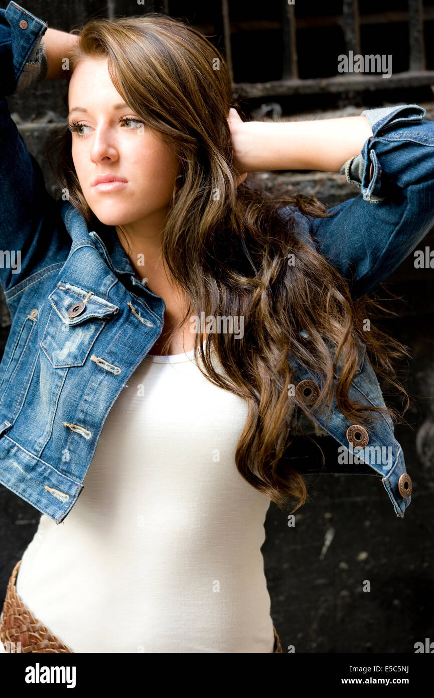 A gorgeous young model wearing a jean jacket on a sunny day Stock Photo ...