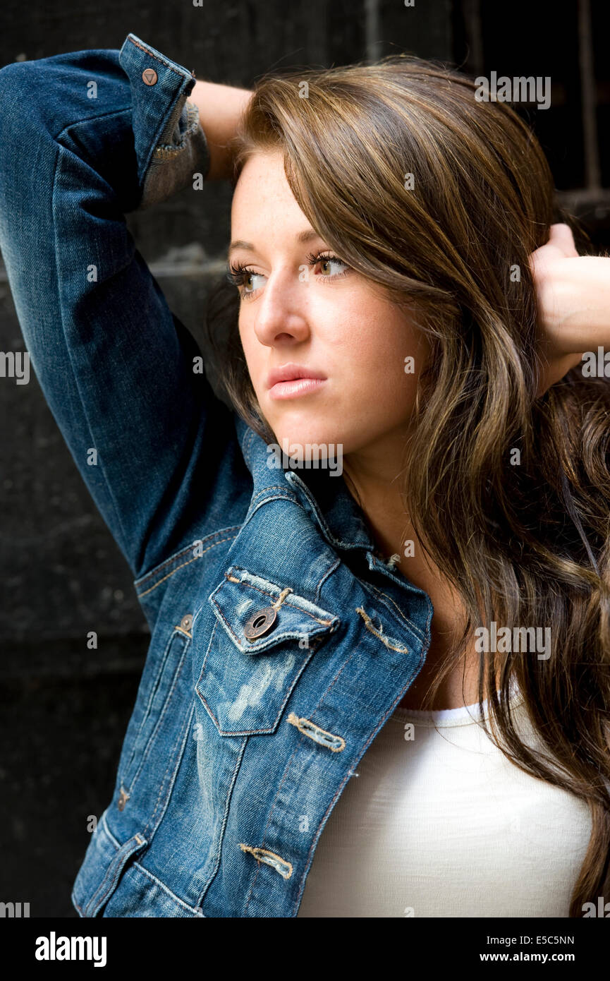 A gorgeous young model wearing a jean jacket on a sunny day Stock Photo ...