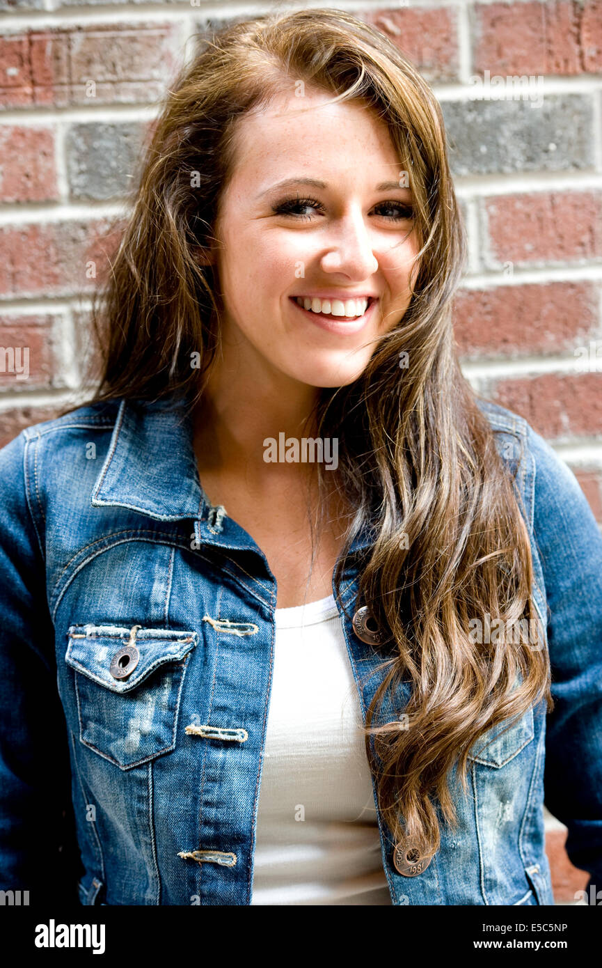 A gorgeous young model wearing a jean jacket on a sunny day Stock Photo ...