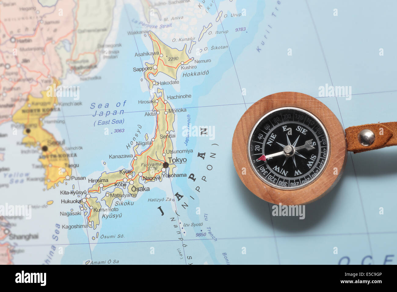 Compass on a map pointing at Japan and planning a travel destination ...