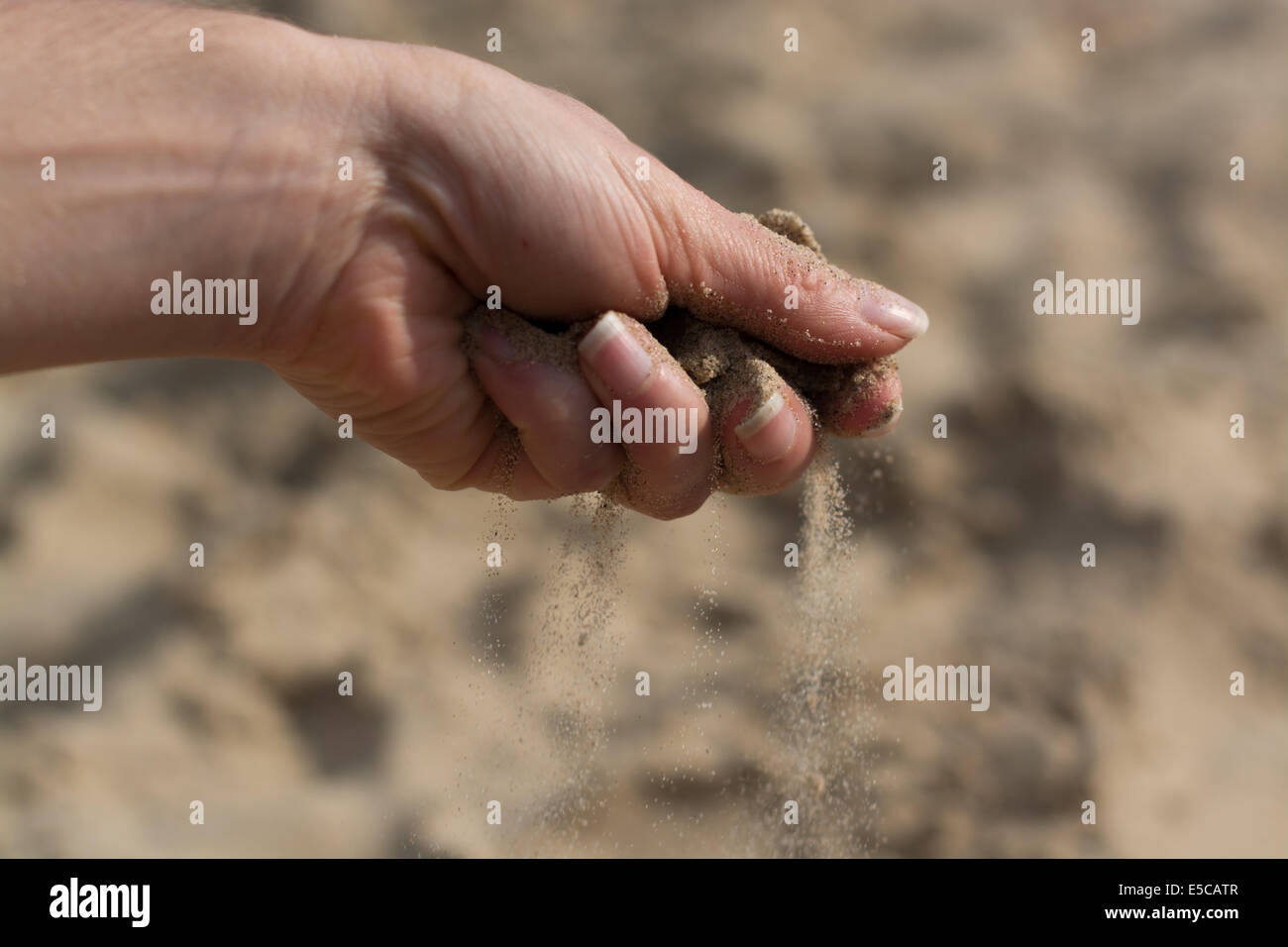 woman holding sand Stock Photo - Alamy