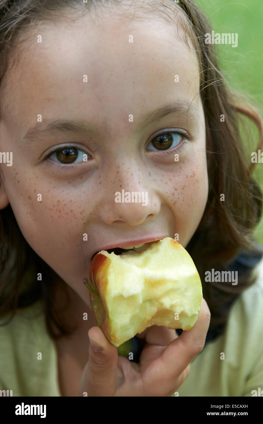 Child Girl Eating Apple, outside, portrait, eye contact Stock Photo - Alamy