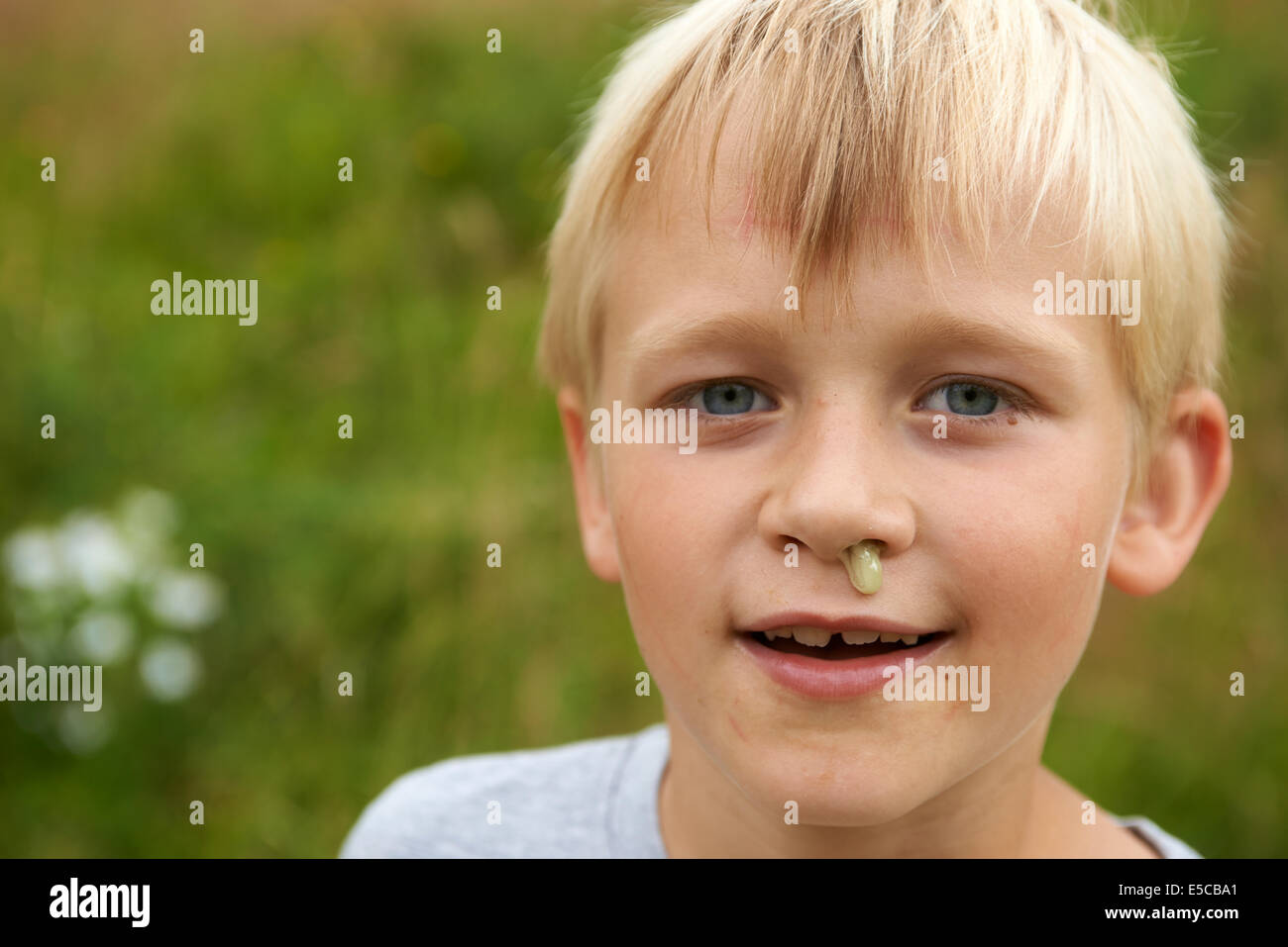 CHILD blond boy WITH RHINITIS without tissue flowing from the nose ...