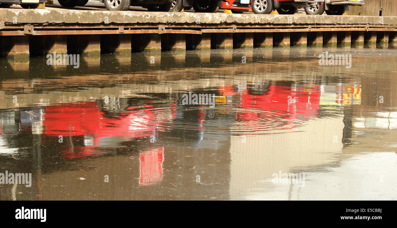 Reflection of parked cars in canal side water Stock Photo - Alamy