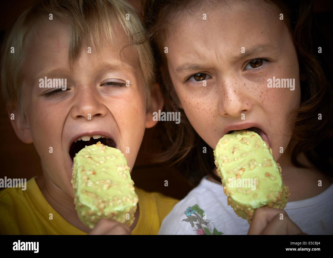 children girl and boy licking ice cream Stock Photo - Alamy