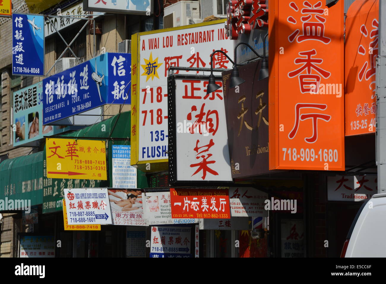 Multitude of street signs on 40th Road in Chinatown, Flushing, Queens ...