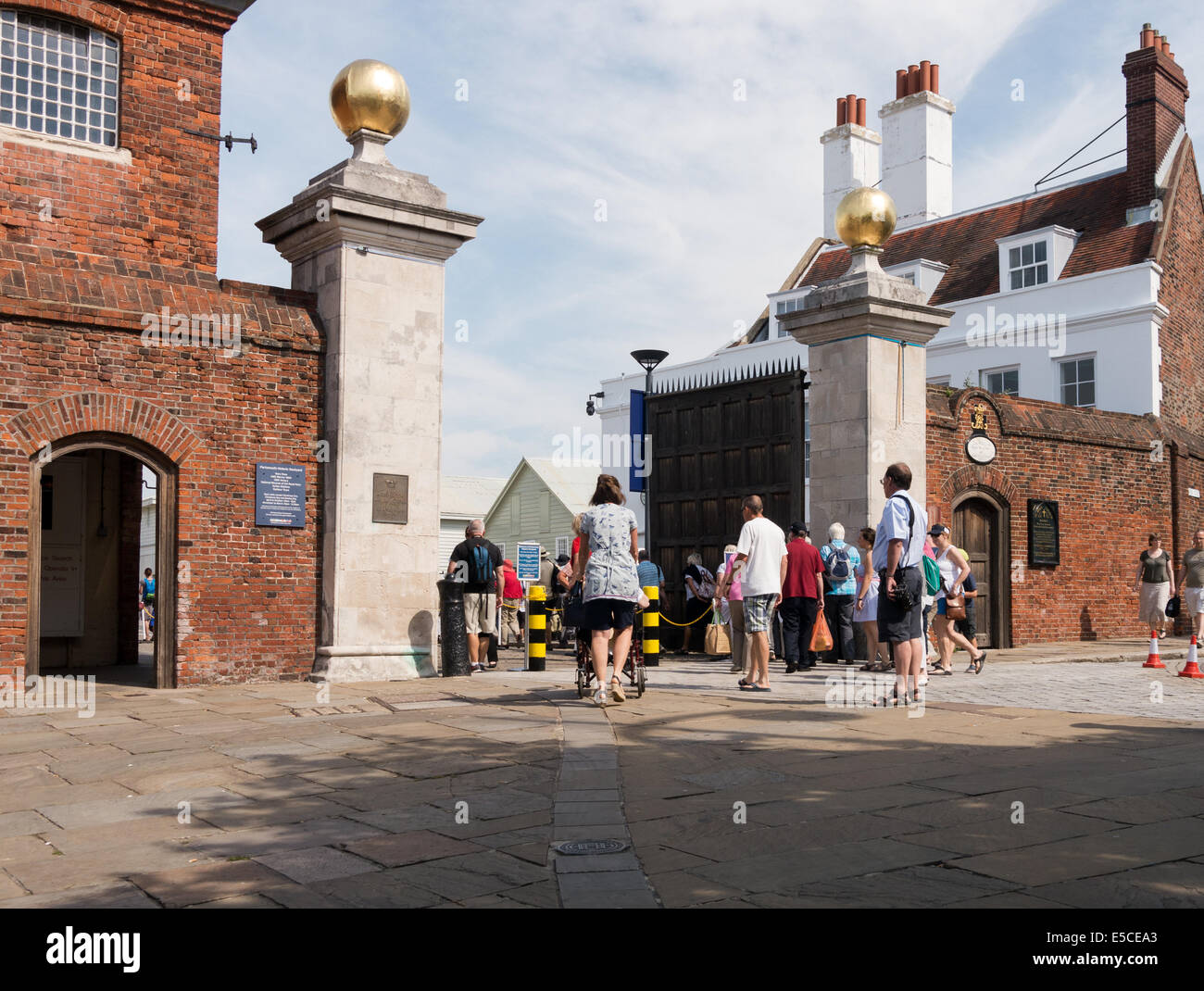 Tourists at the main entrance to Portsmouth historic dockyard, England ...