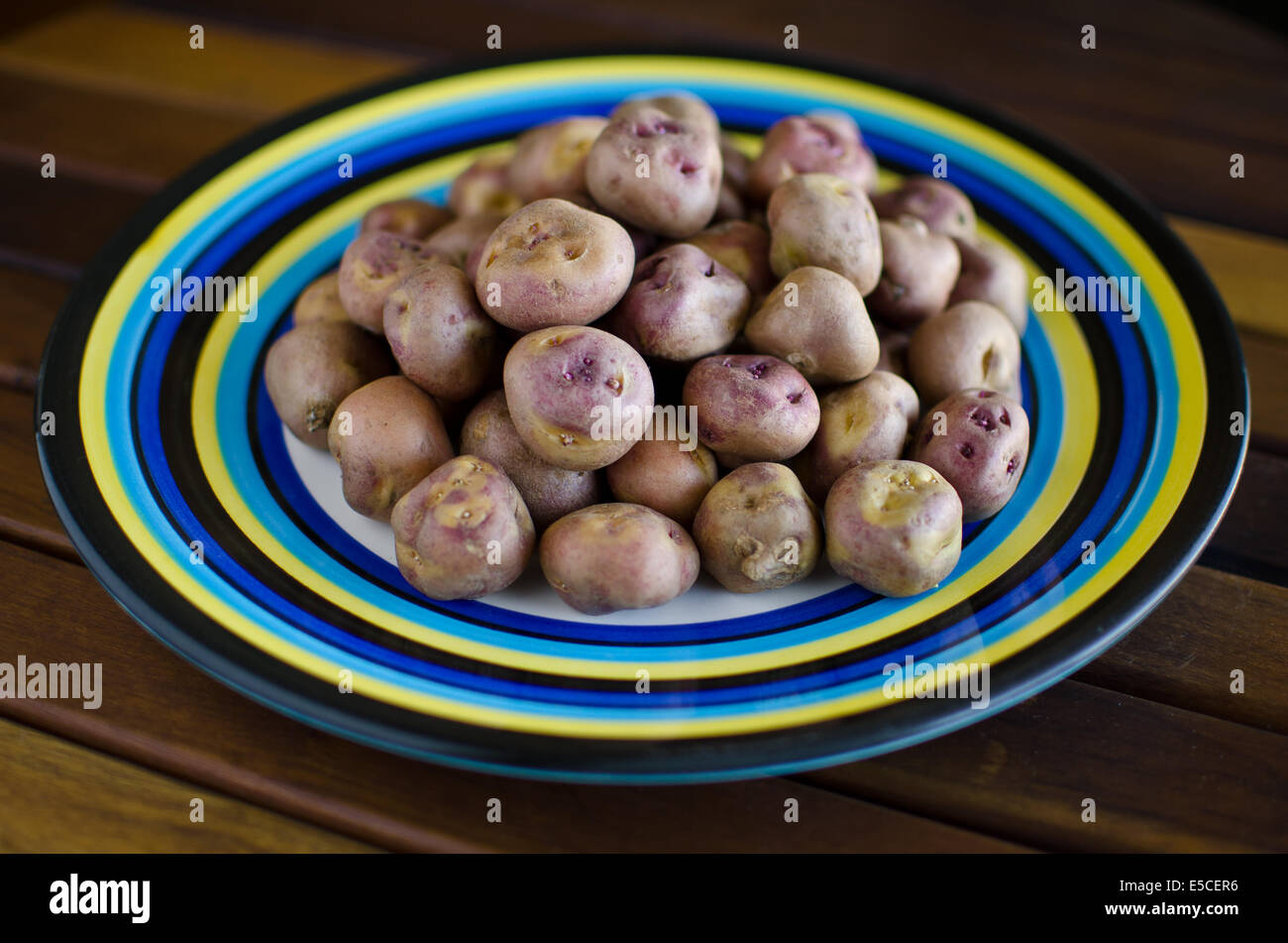 Andean potatoes on an elegant dish over a wooden table Stock Photo - Alamy