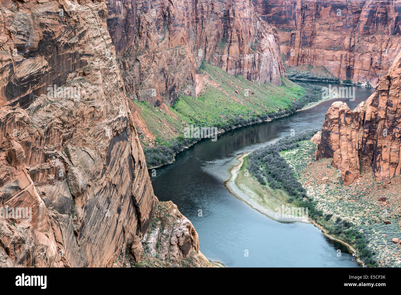 Colorado River and sandstone cliffs dowstream from the Glen Canyon Dam ...