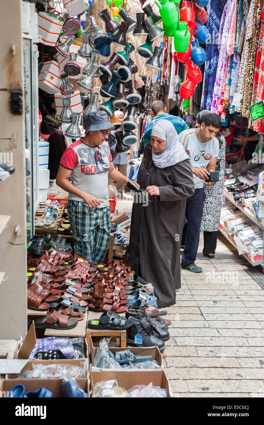 A vendor and a buyer at the market in the old city of Nazareth, Israel ...