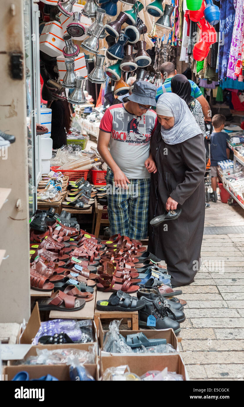 A vendor and a buyer at the market in the old city of Nazareth, Israel ...
