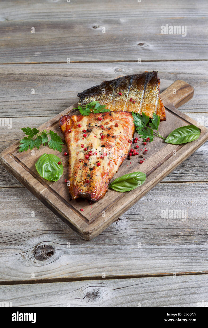 Vertical view of smoked salmon fillets, fresh out of cooker, with ...