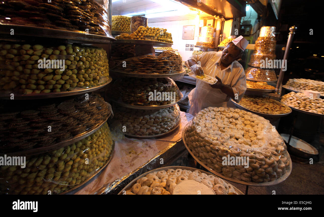 Amman, Jordan. 27th July, 2014. A Jordanian man sells sweets for the ...