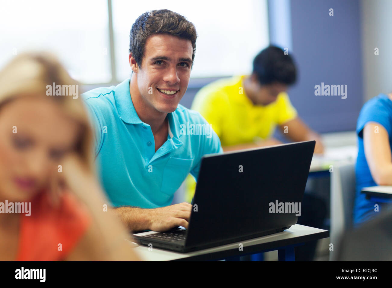 handsome college boy using laptop in lecture hall Stock Photo - Alamy