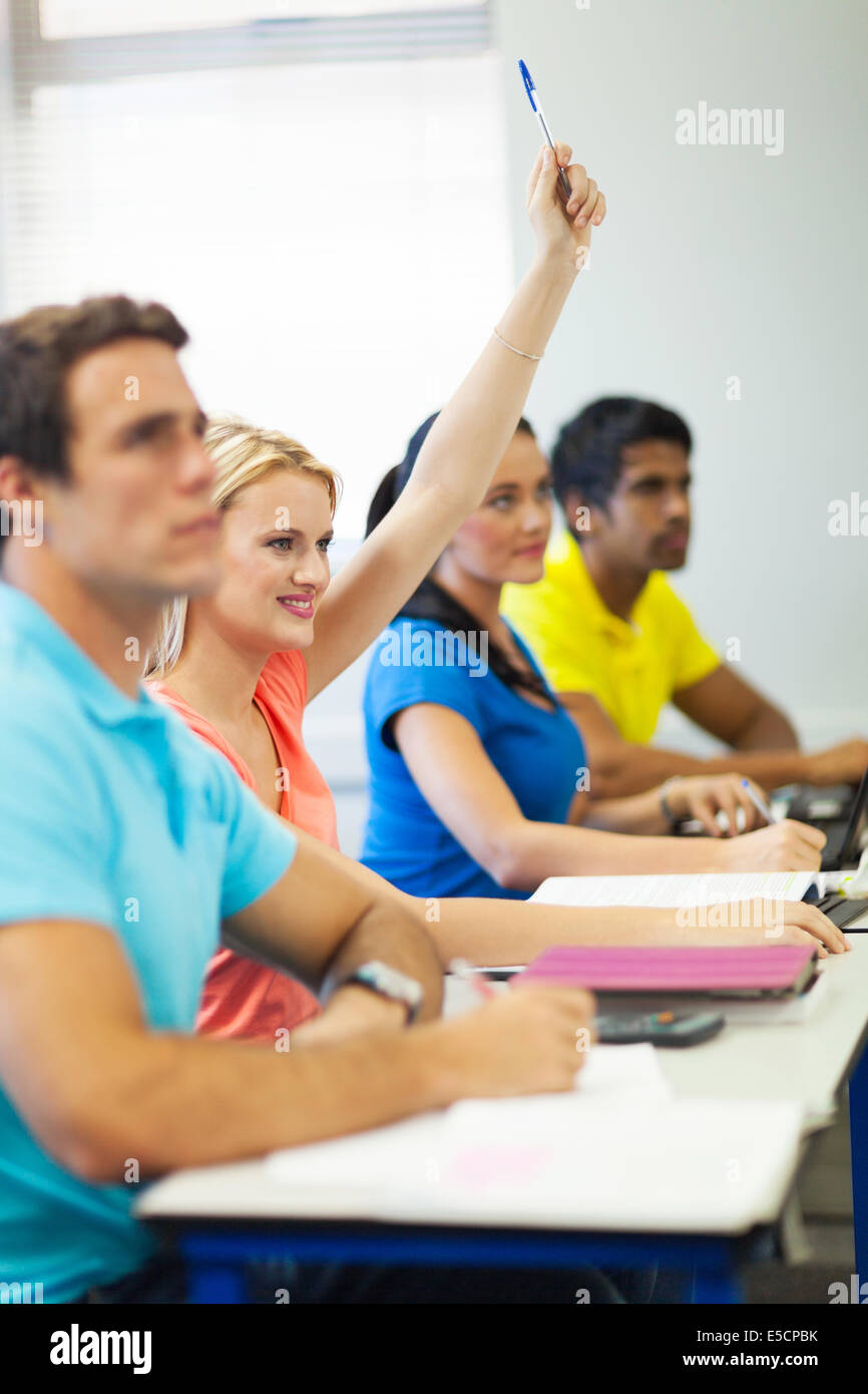 beautiful female university student asking question in lecture room ...